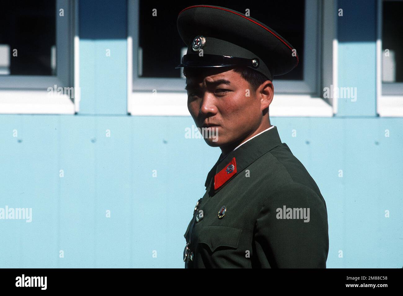 A North Korean security officer observes visitors touring the United ...