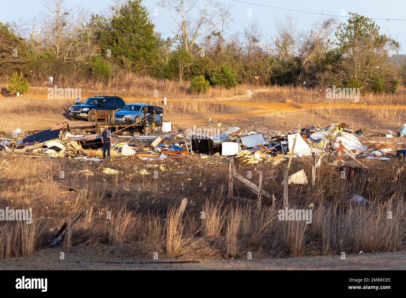 Scott Wayman, foreground left, examines his former rental home at 1349 ...