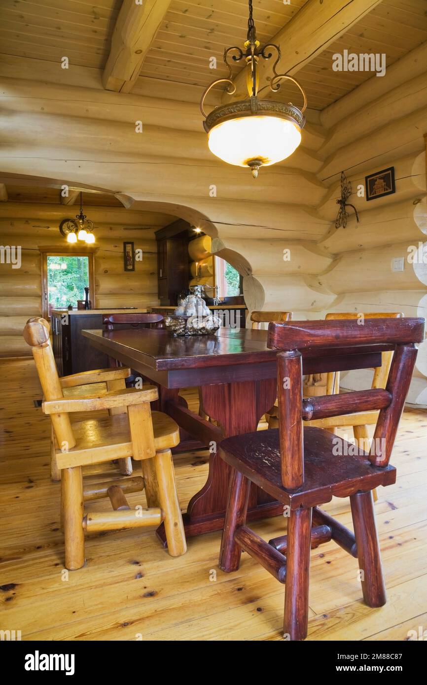 Cedar wood dining table with natural and stained high back log chairs ...
