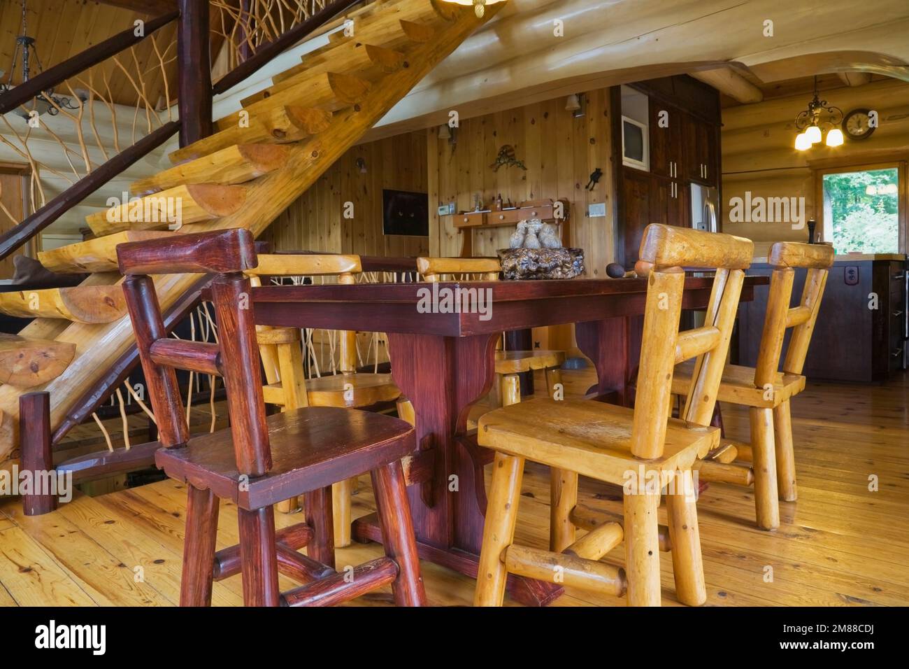 Cedar wood dining table with high back log chairs in dining room and ...