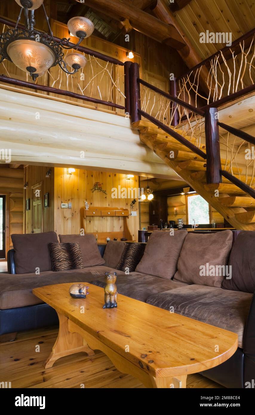 Wooden coffee table and brown leather L shaped sofa set in living room ...