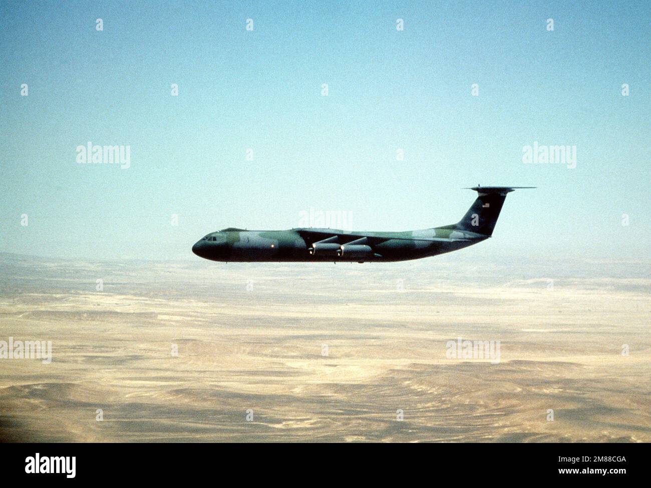 An air-to-air left side view of a 437th Military Airlift Wing C-141B ...