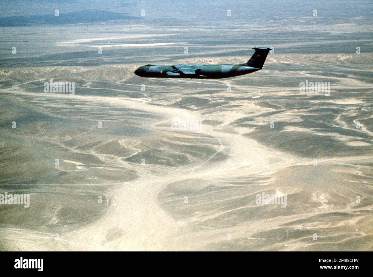 An air-to-air left side view of a 437th Military Airlift Wing C-141B ...