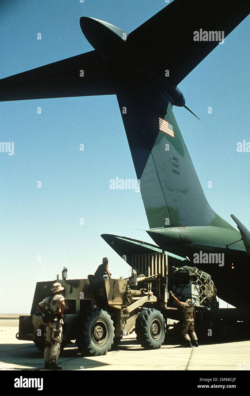A Case M-4K rough terrain forklift is used to load a C-141B Starlifter ...