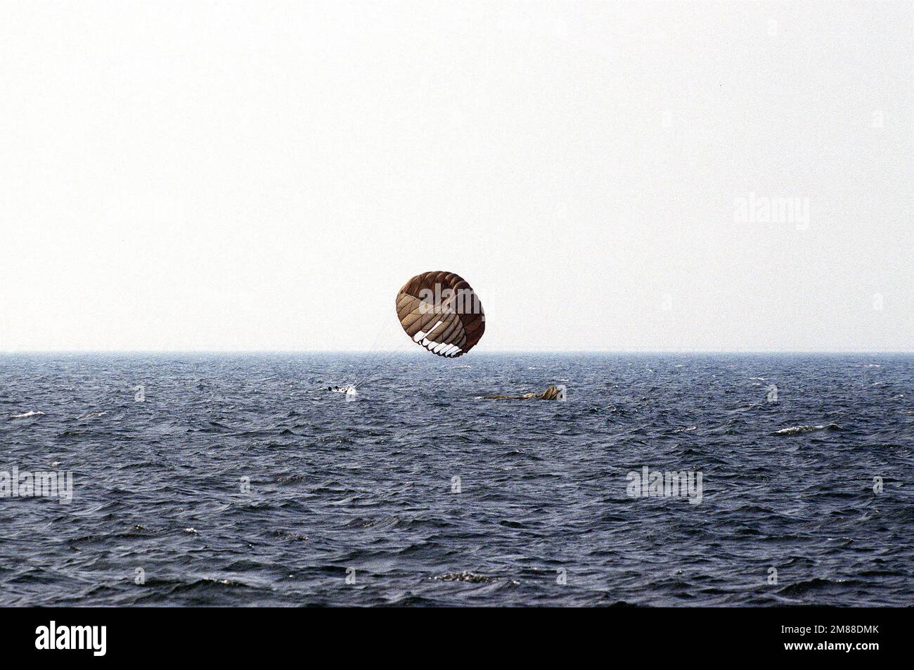 Sea-Air-Land (SEAL) team members parachute into the sea during a ...