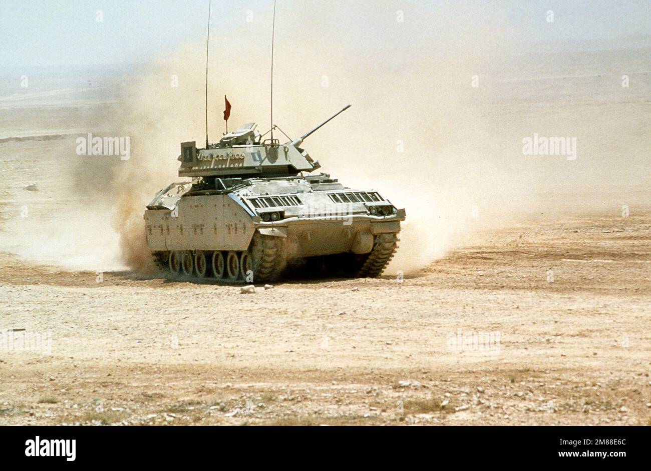 An M-2 Bradley infantry fighting vehicle maneuvers in the desert during ...