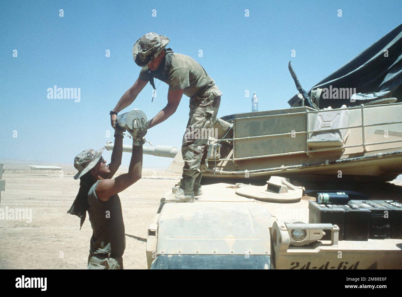 U.S. soldiers from Co. D, 3rd Plt., 4th Bn., 64th Armor, load 120mm ...