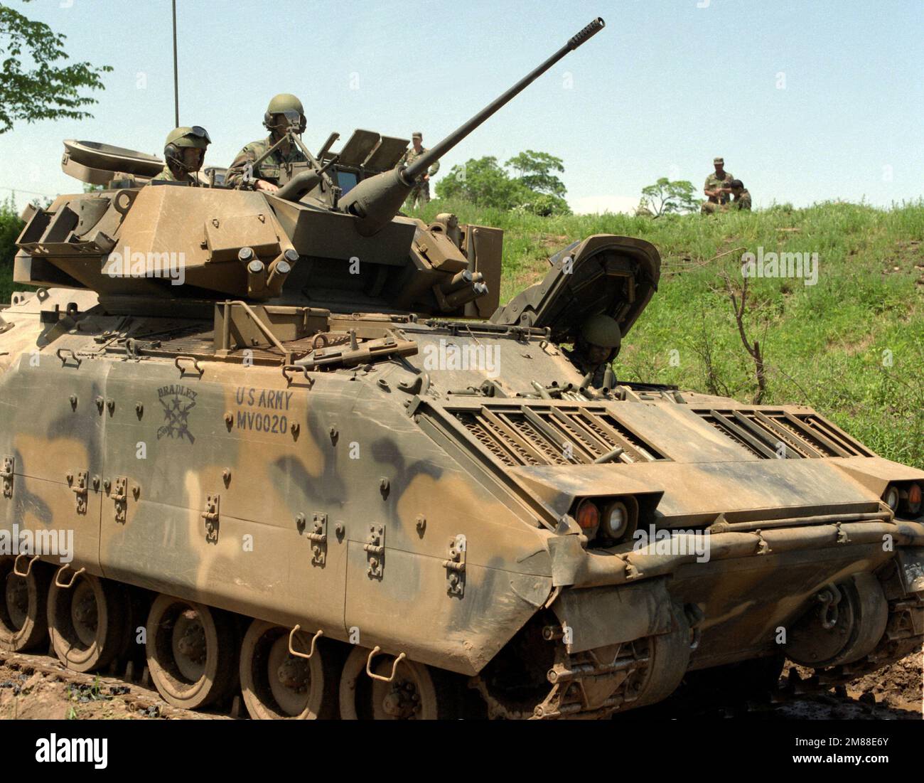 Crewmen in the coupla of an M-2 Bradley infantry fighting vehicle ...