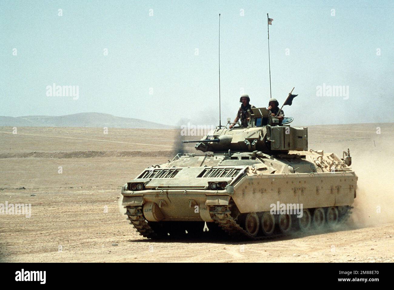An M-2 Bradley infantry fighting vehicle maneuvers in the desert during ...