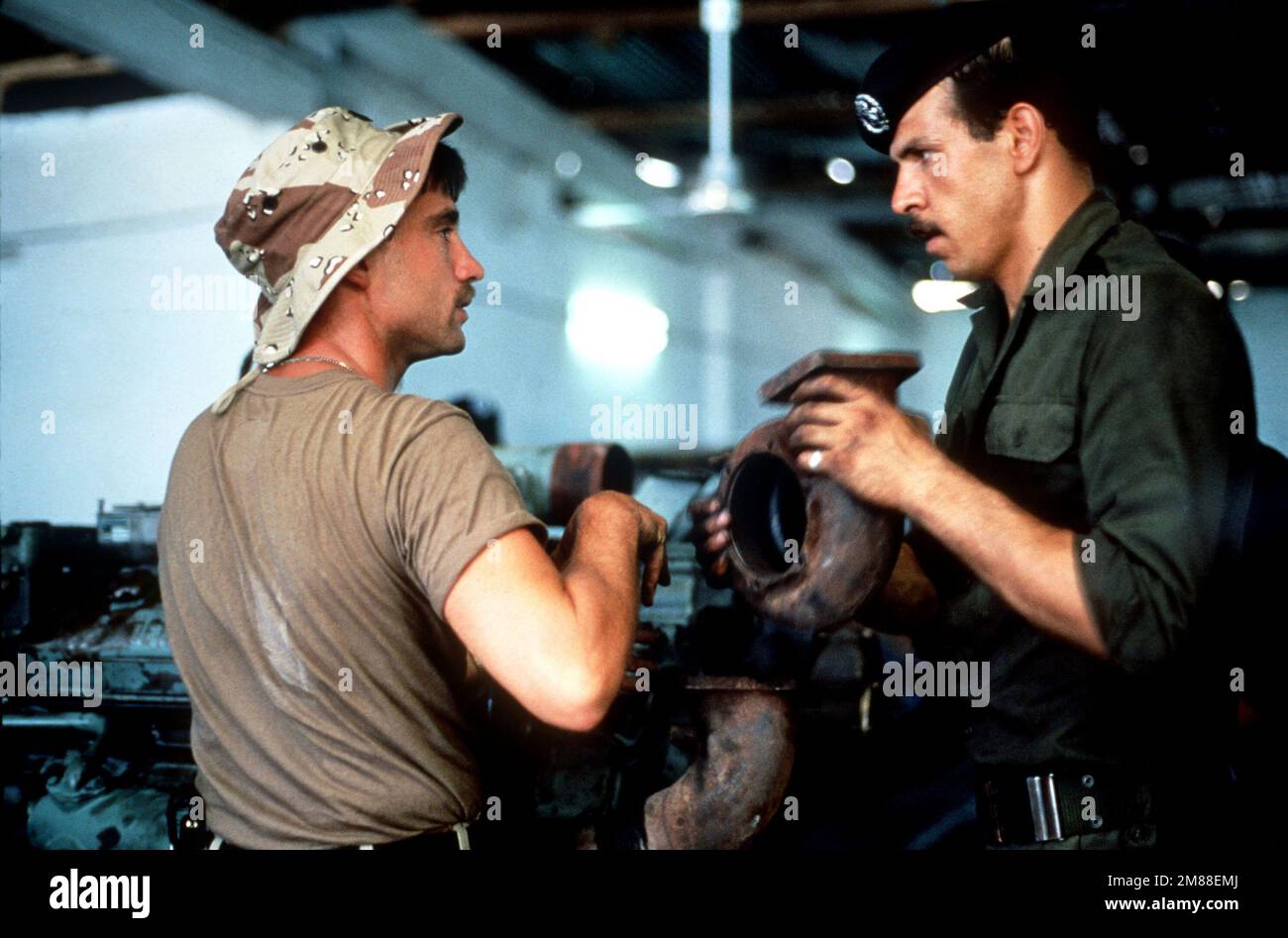 A US Coast Guard reservist works with a member of the Jordanian ...
