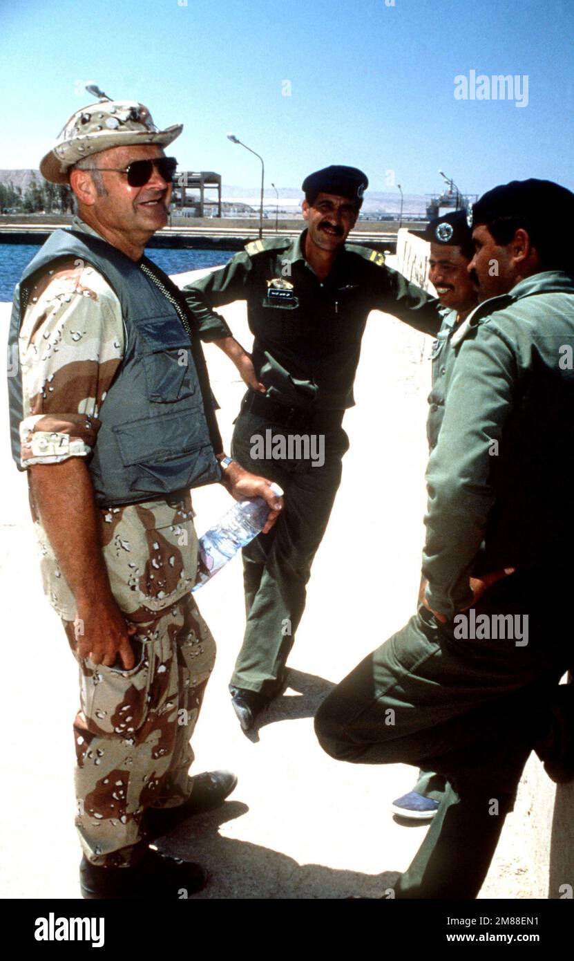 A chief boatswain's mate from the US Coast Guard converse with members ...