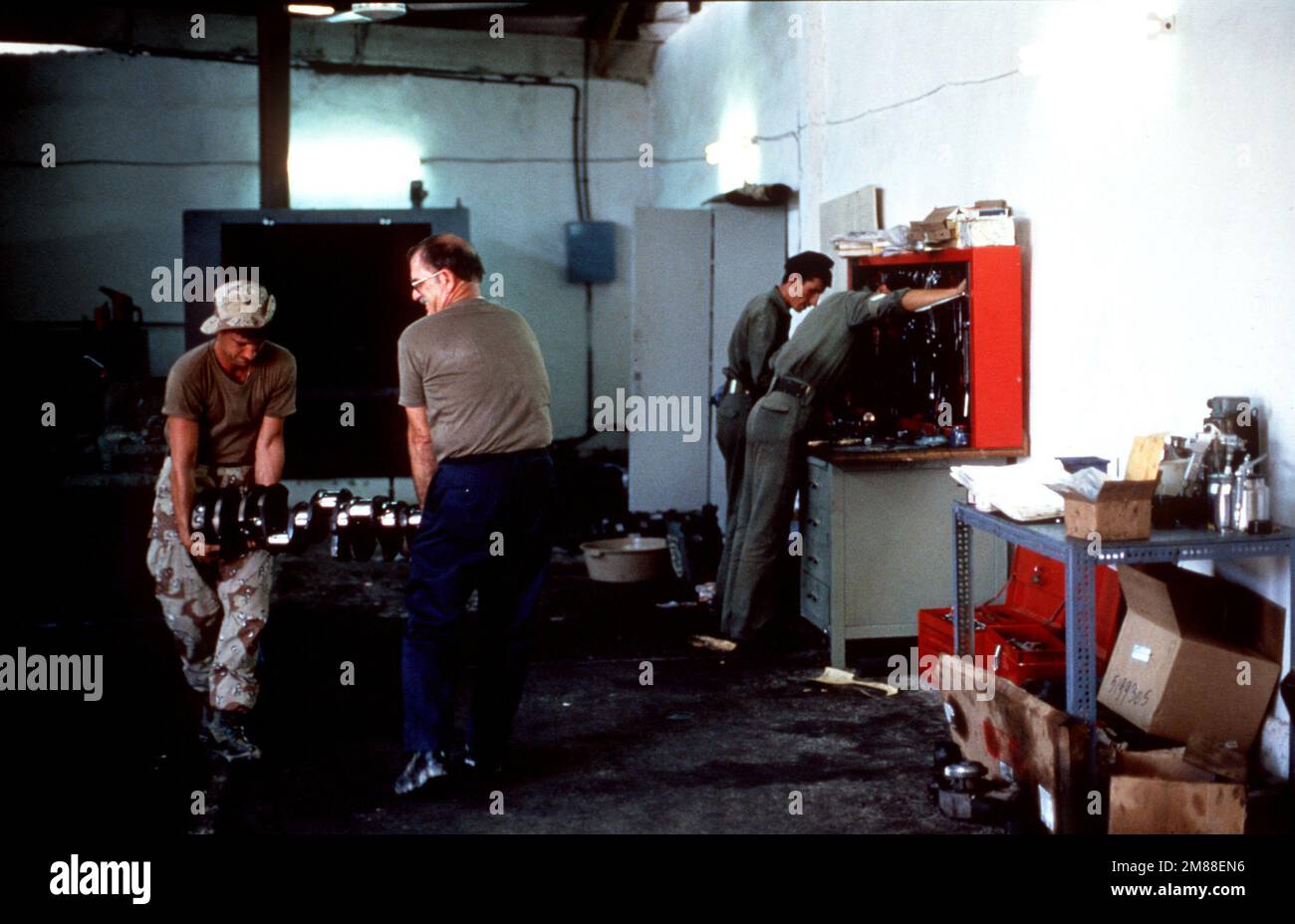 A US Coast Guard reservist works with a Jordanian mechanic in a marine ...