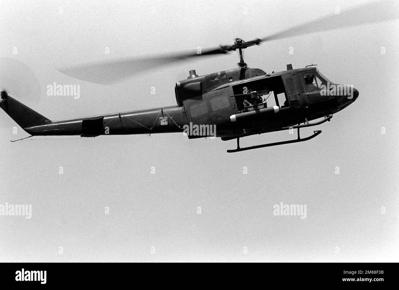 A right side view of a UH-1N Iroquois helicopter in flight. The ...