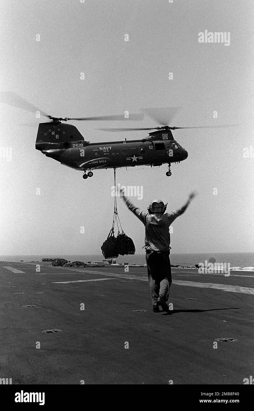 A flight deck crewman directs a Helicopter Combat Support Squadron 5 ...