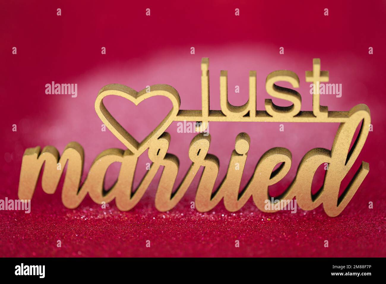 wedding symbol. just married inscription on a bright pink fuchsia ...