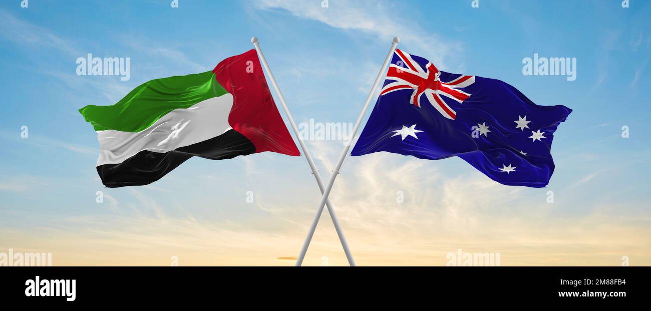two crossed flags Australia and United Arab Emirates waving in wind at ...