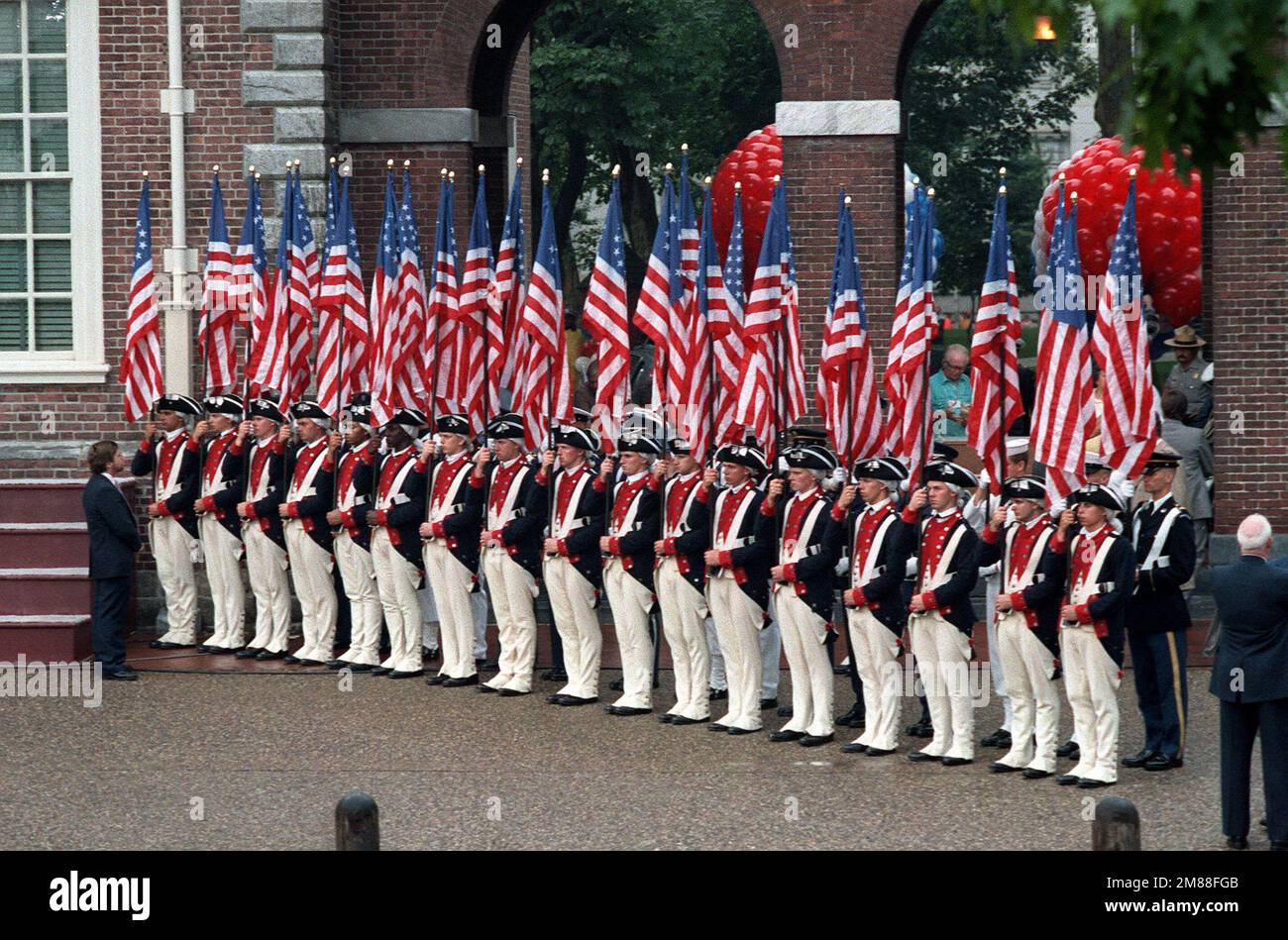 Soldiers dressed in Revolutionary War-era uniforms presents the colors ...
