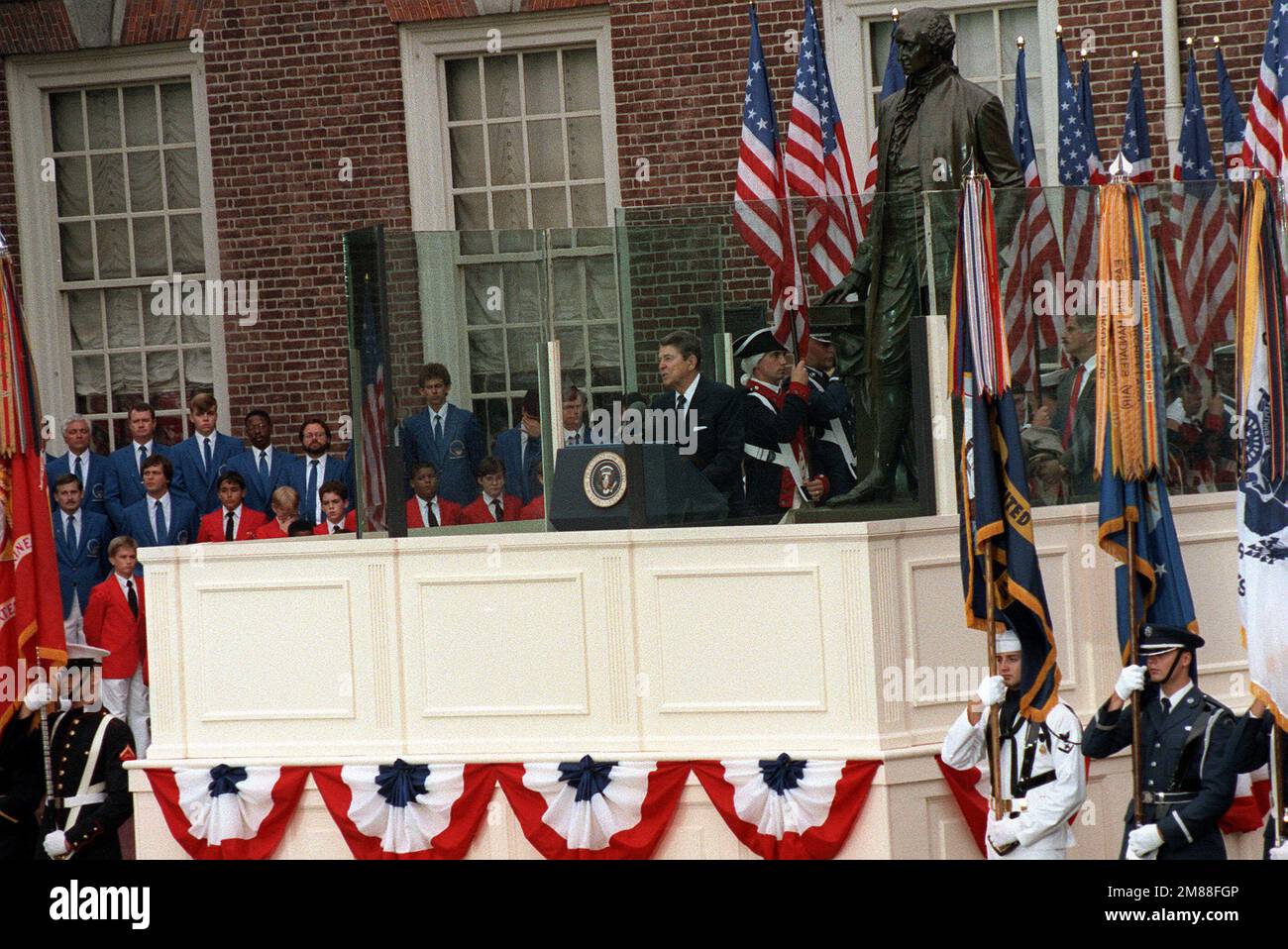 President Ronald Reagan makes an address at the start of a parade ...