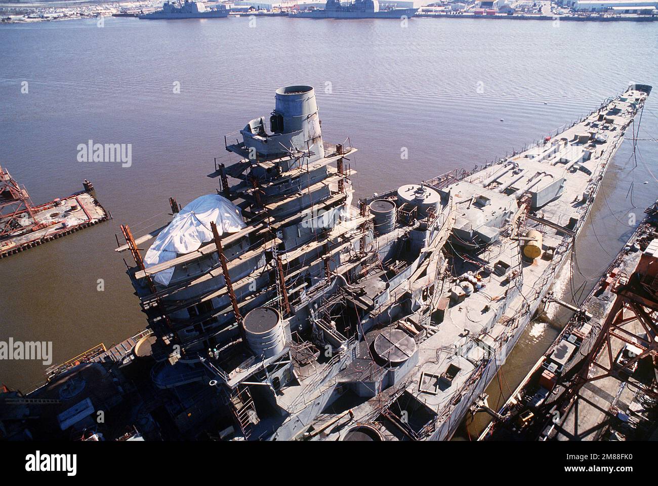 Scaffolding surrounds the superstructure of the battleship WISCONSIN (BB-64). The ship is ...