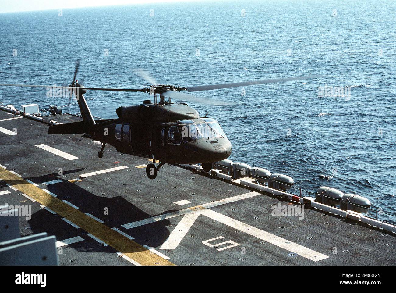 A U.S. Army UH-60 Black Hawk (Blackhawk) helicopter prepares to touch ...