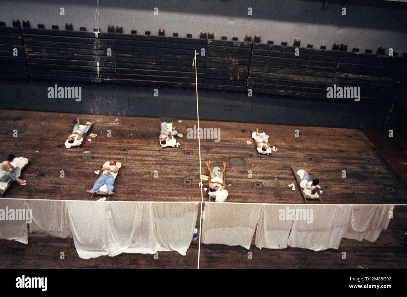 Detainees from the captured Iranian mine-laying ship IRAN AJR rest ...