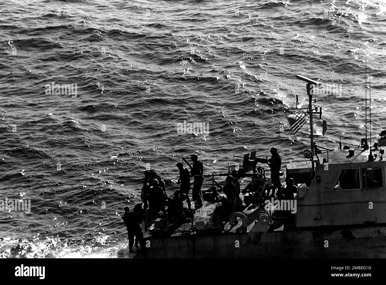 Crew members from the captured Iranian mine-laying ship IRAN AJR are ...