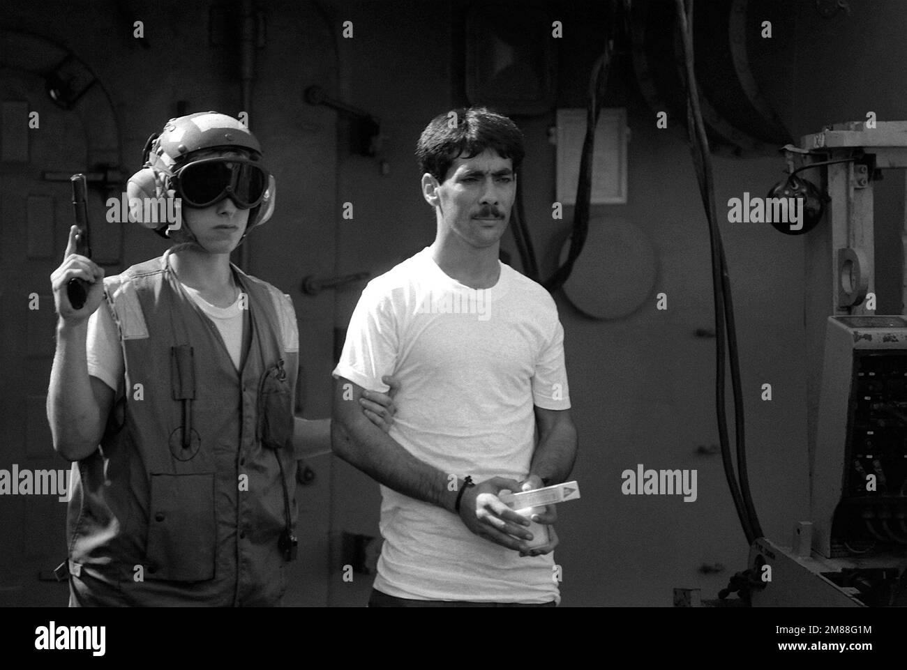An armed crew member aboard the amphibious transport dock USS RALEIGH ...