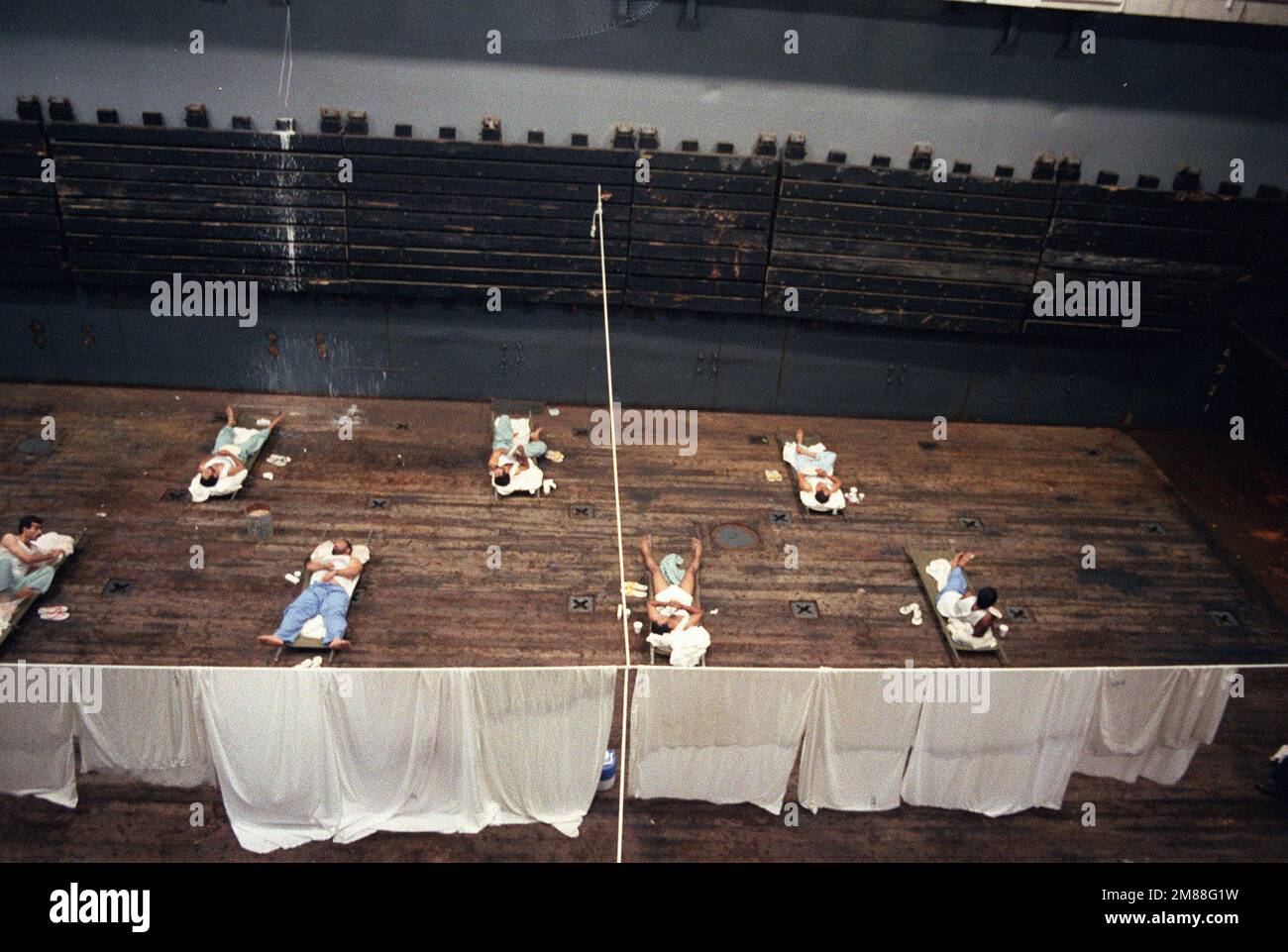 Detainees from the captured Iranian mine-laying ship IRAN AJR rest ...