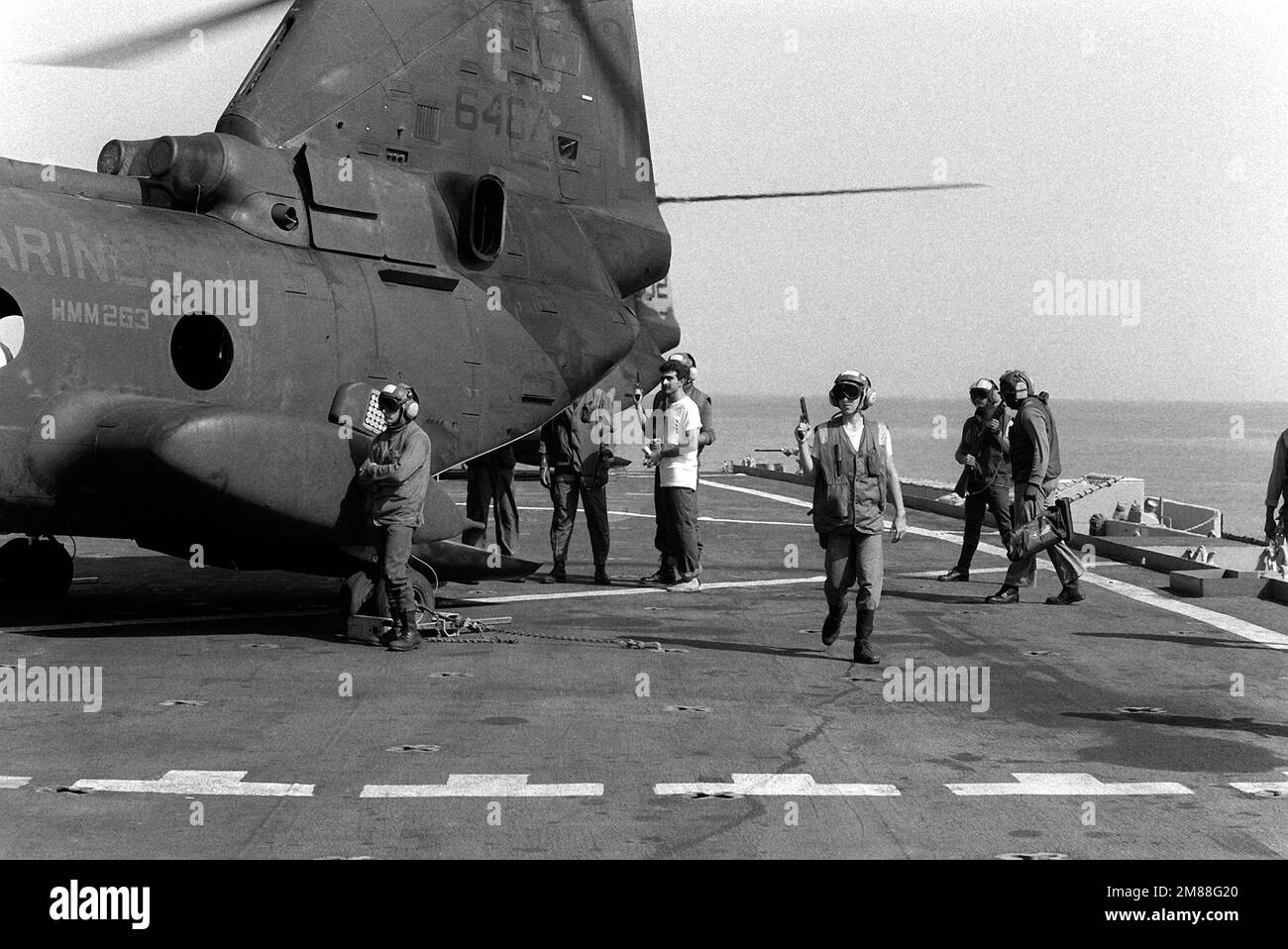 Crewmen aboard a U.S. naval ship escort Iranian detainees from the mine ...
