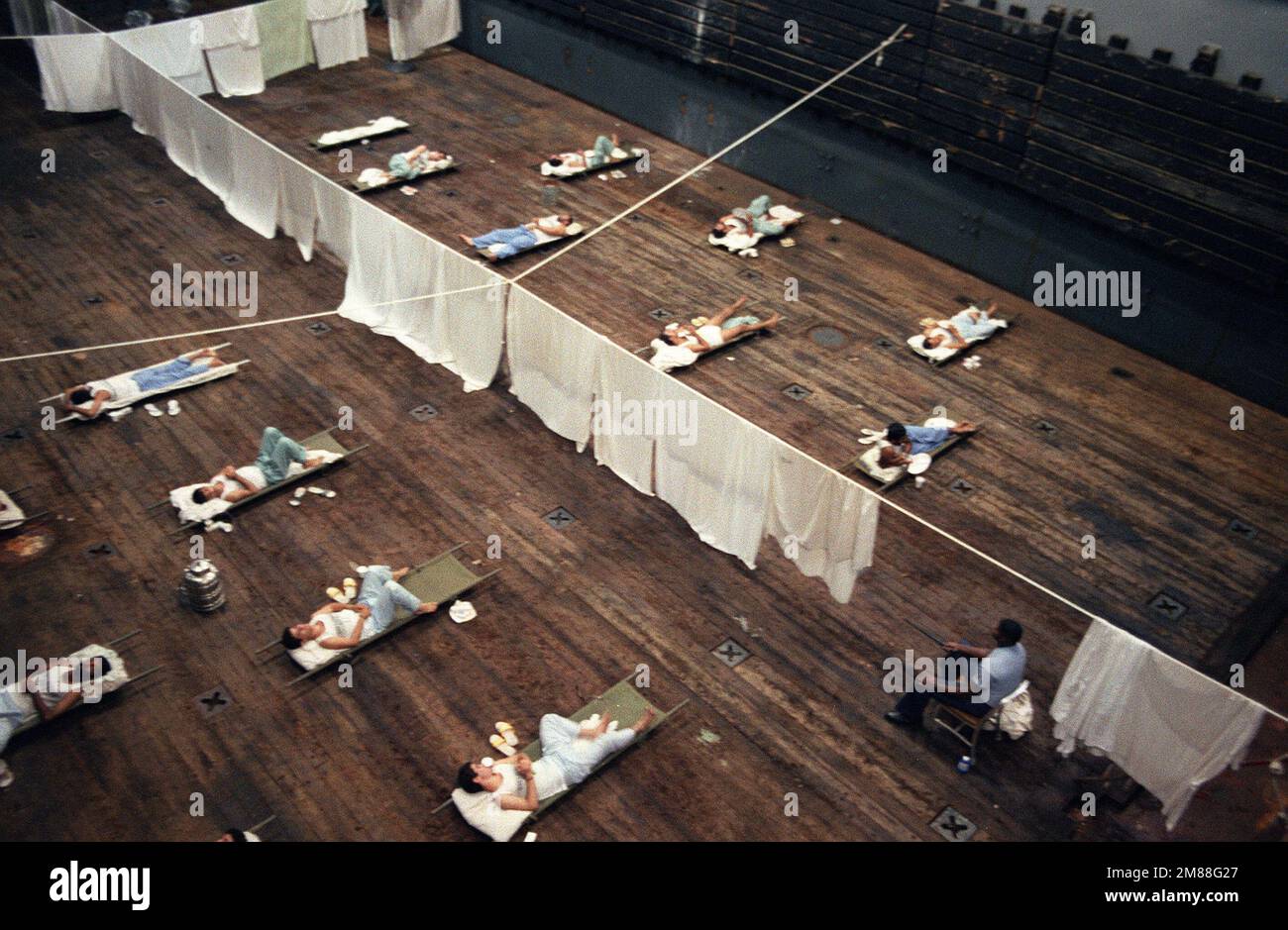 Detainees from the captured Iranian mine-laying ship IRAN AJR rest ...