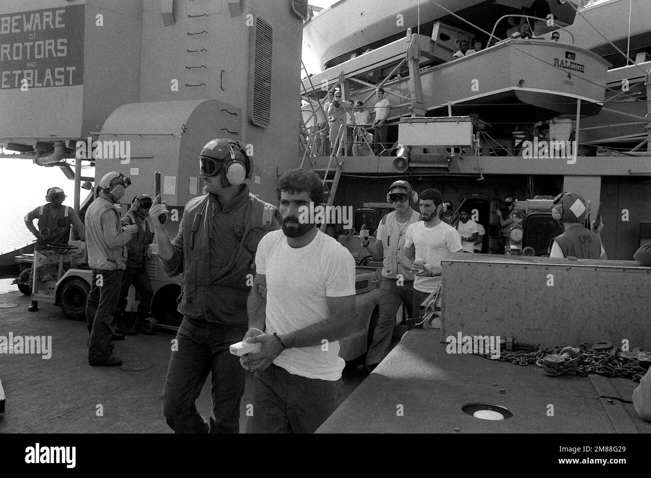 An armed crew member aboard the amphibious transport dock USS RALEIGH ...