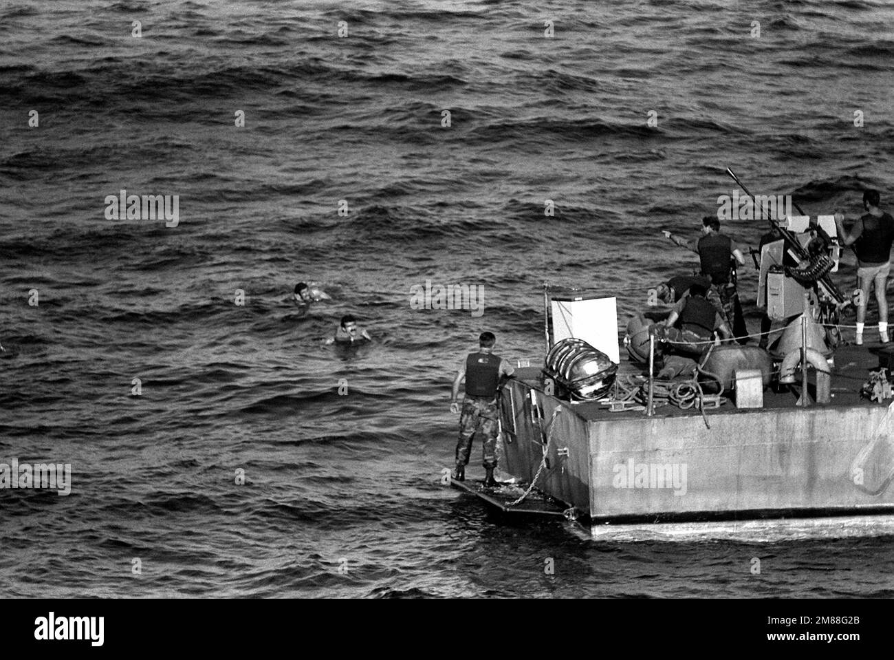 Crew members from the captured Iranian mine-laying ship IRAN AJR are ...