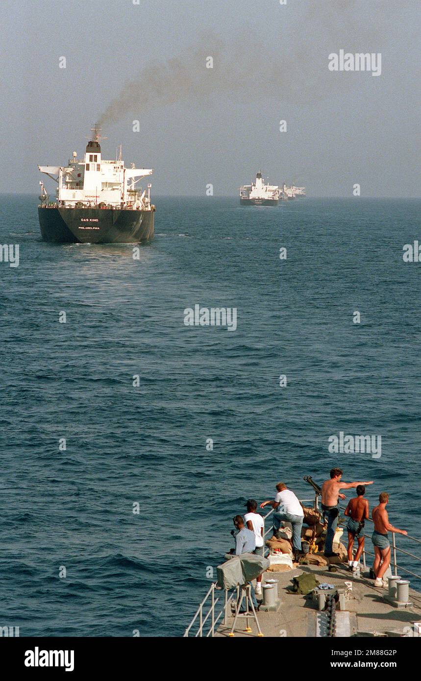 Crew members stand watch on the bow of the guided missile destroyer USS ...