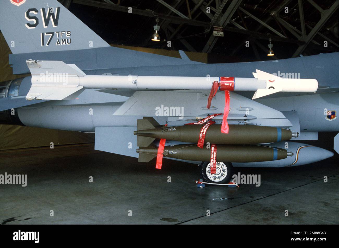 An AIM-9 Sidewinder missile is mounted on the right wing tip and three ...