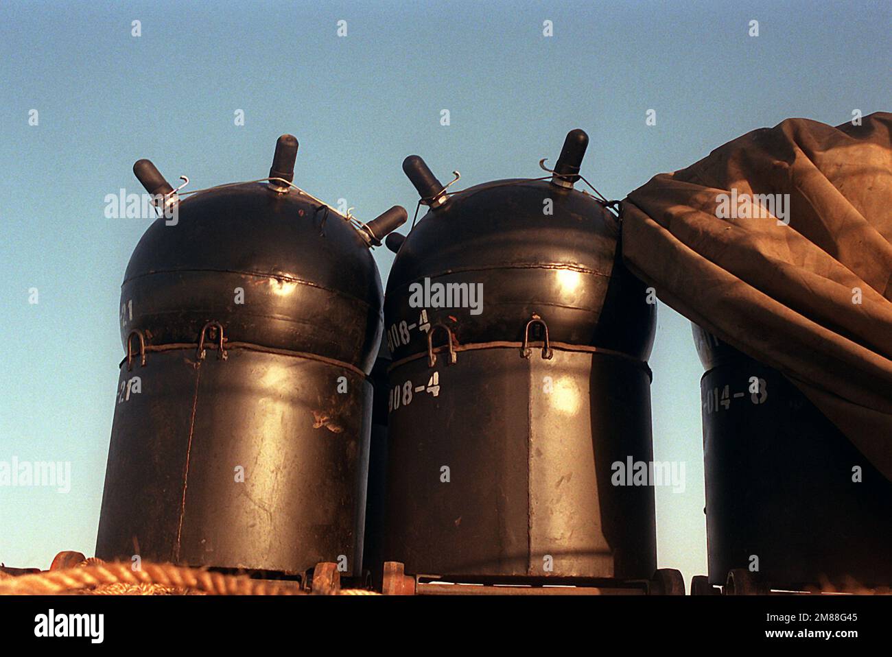 Contact mines partially covered by a tarpaulin on the deck of the captured Iranian mine-laying ...