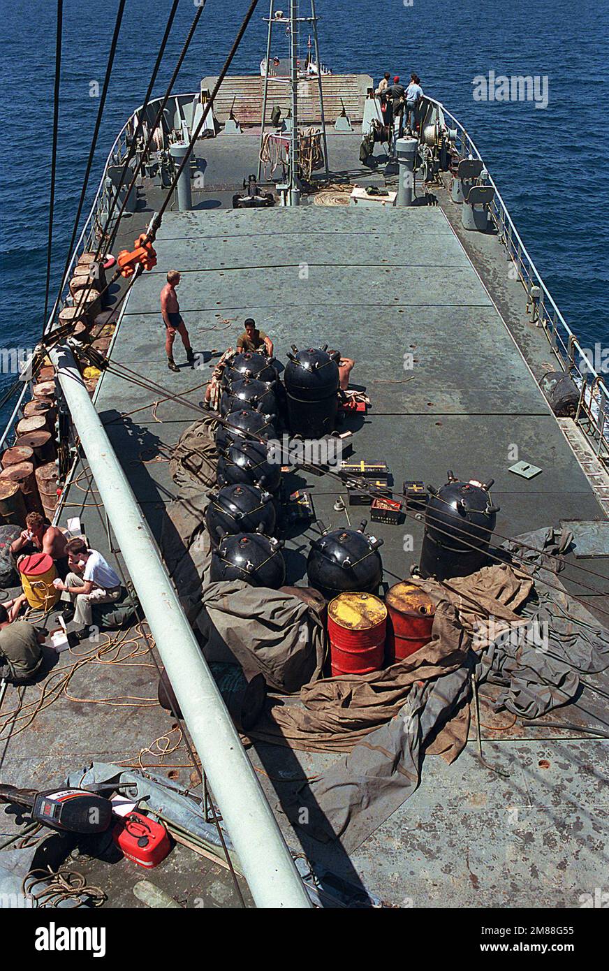 Contact mines partially covered by a tarpaulin on the deck of the ...