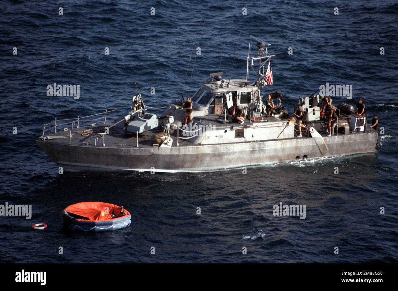 A U.S. Navy Mark 3 patrol craft pulls alongside a raft from the Iranian ...