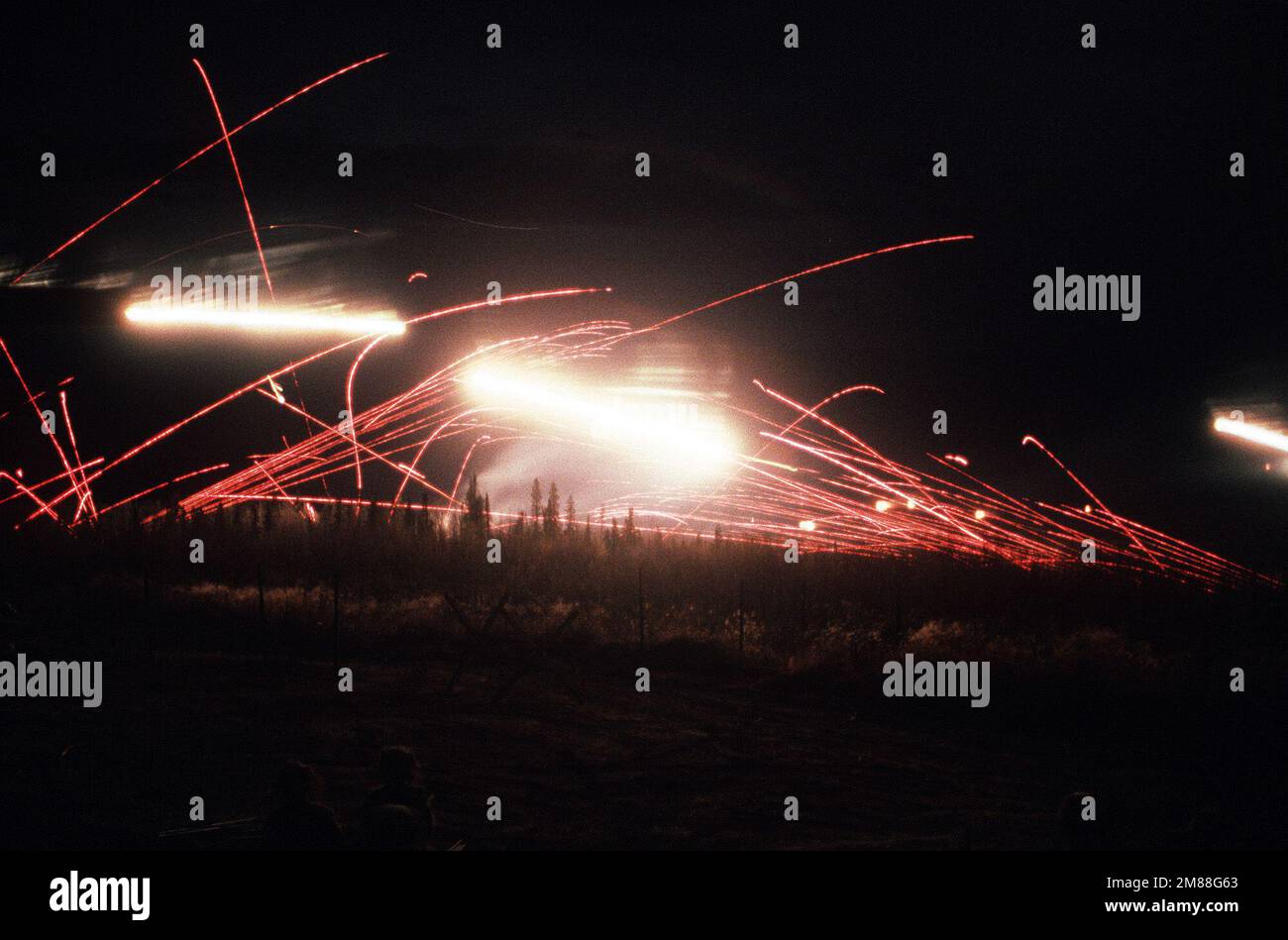 A nighttime view of tracer fire illuminating members of Co. B, 2nd Bn ...