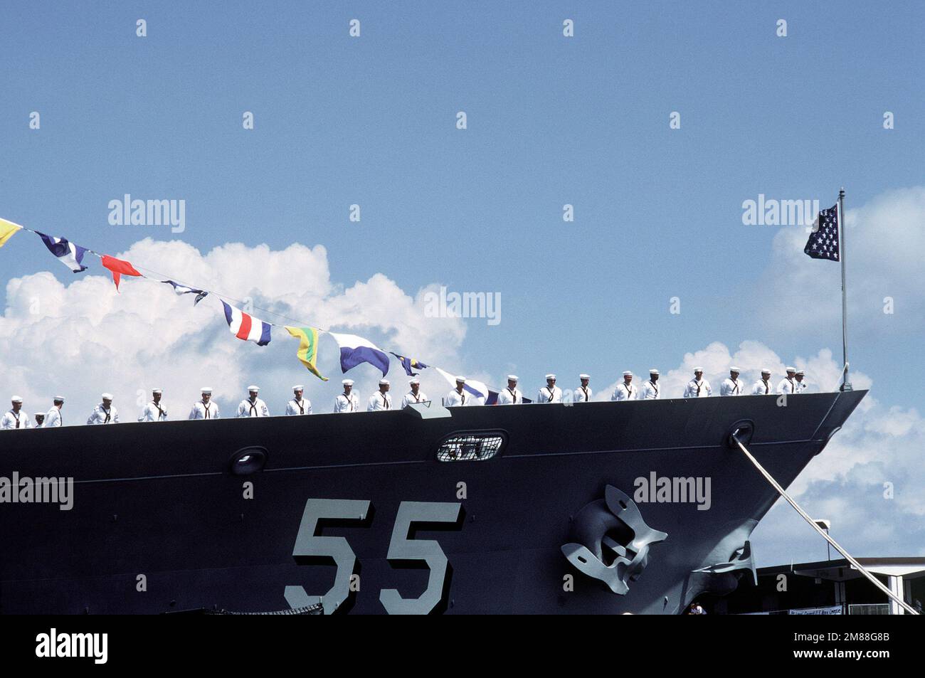 Crew members man the rail at the commissioning ceremonies of the guided ...