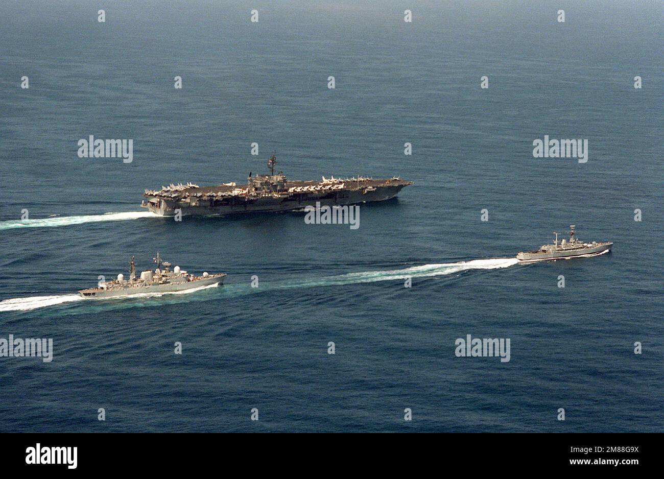 An aerial starboard quarter view of the aircraft carrier USS KITTY HAWK ...