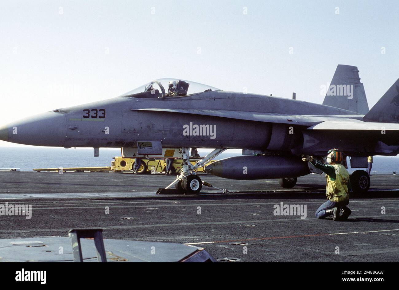 A plane director gives the launch signal to the pilot of a Strike ...