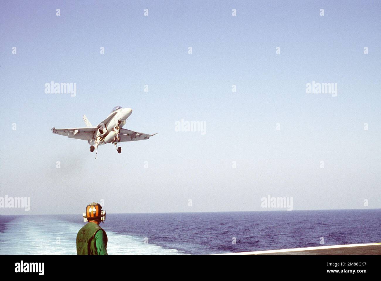 A Fighter Squadron 106 (VF-106) F/A-18 Hornet aircraft approaches for a ...