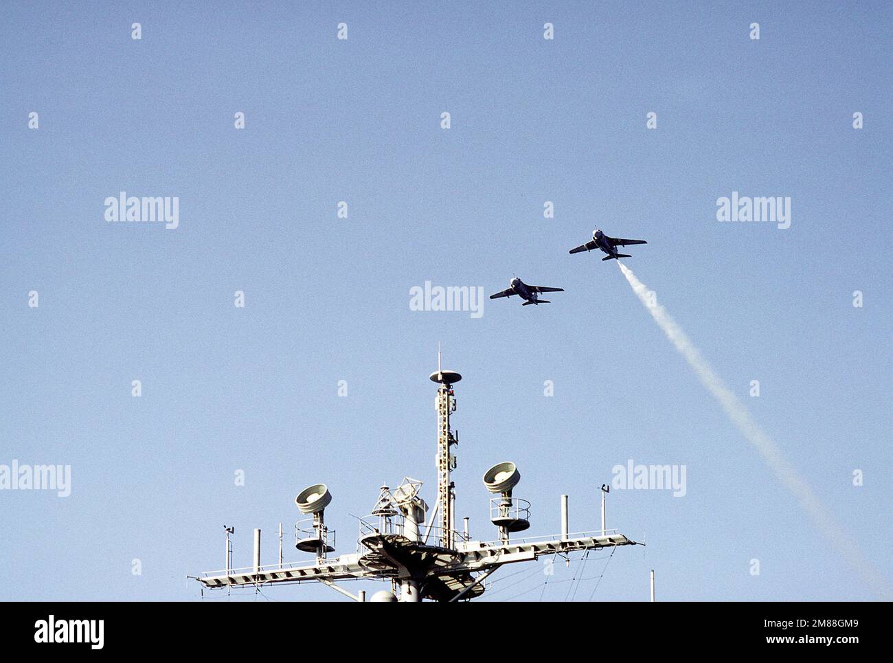 A-6E Intruder aircraft fly over the mast of the nuclear-powered ...