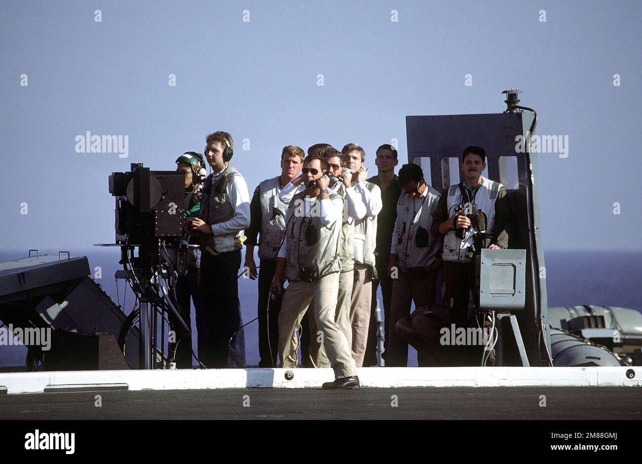 Landing signal officers (LSOs) direct aircraft landing approaches from ...