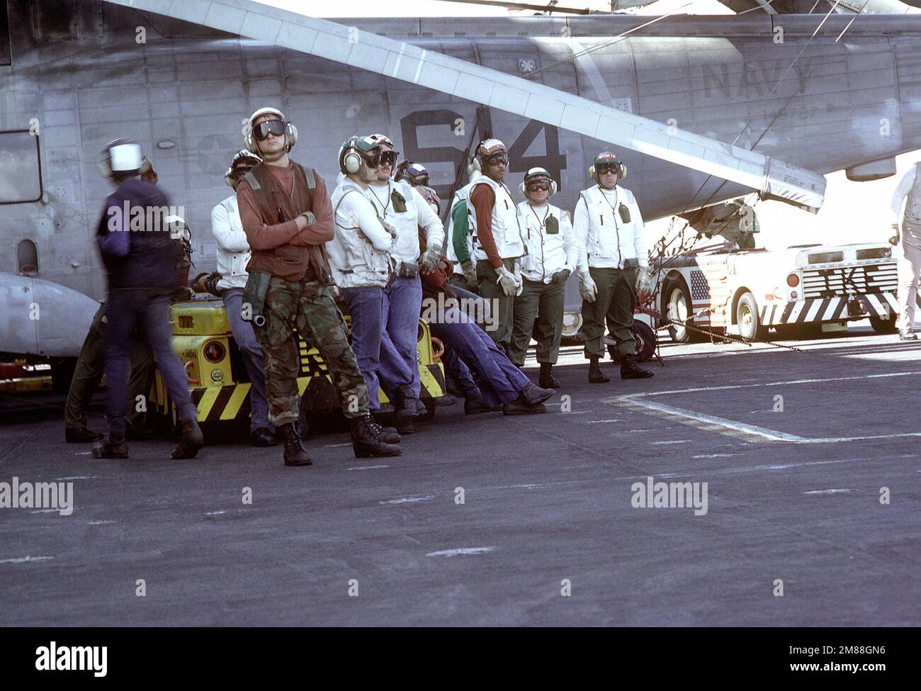 A plane captian and other flight deck crew members stand by on the ...