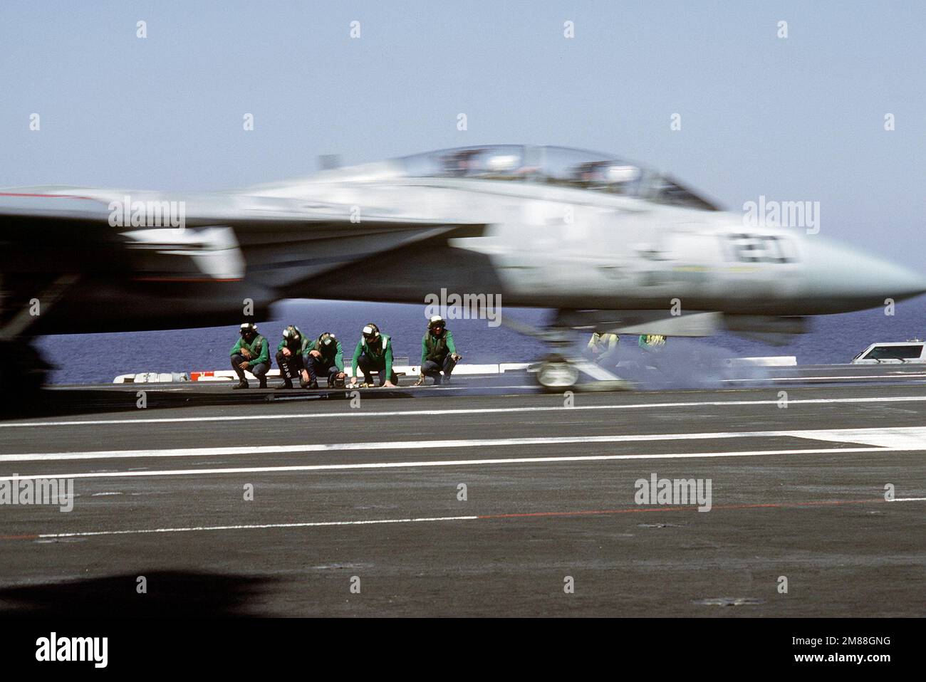Catapult crew members stand by as a Fighter Squadron 101 (VFA-101) F ...