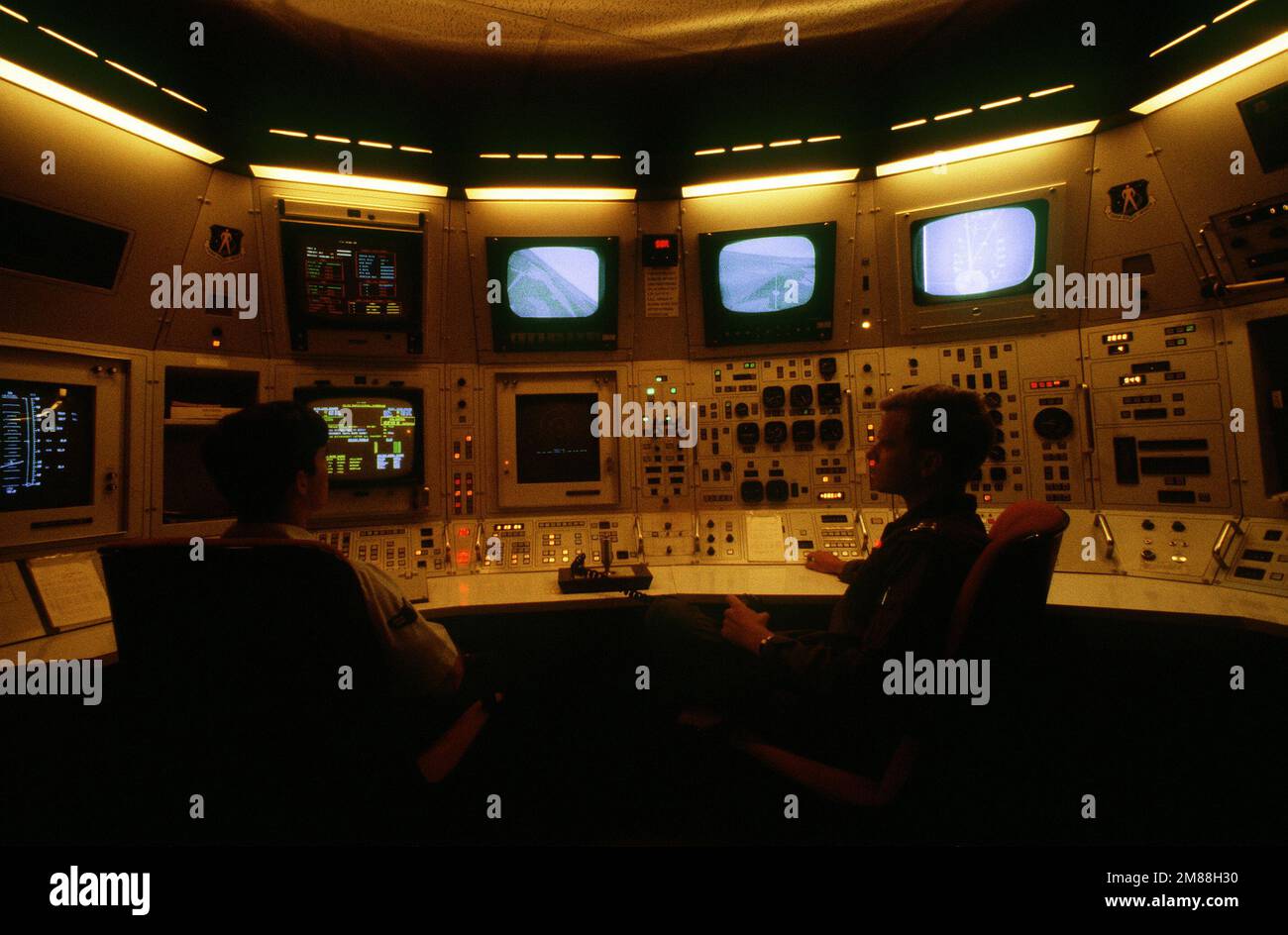Air Force enlisted technician and flying officer monitors the T-V ...