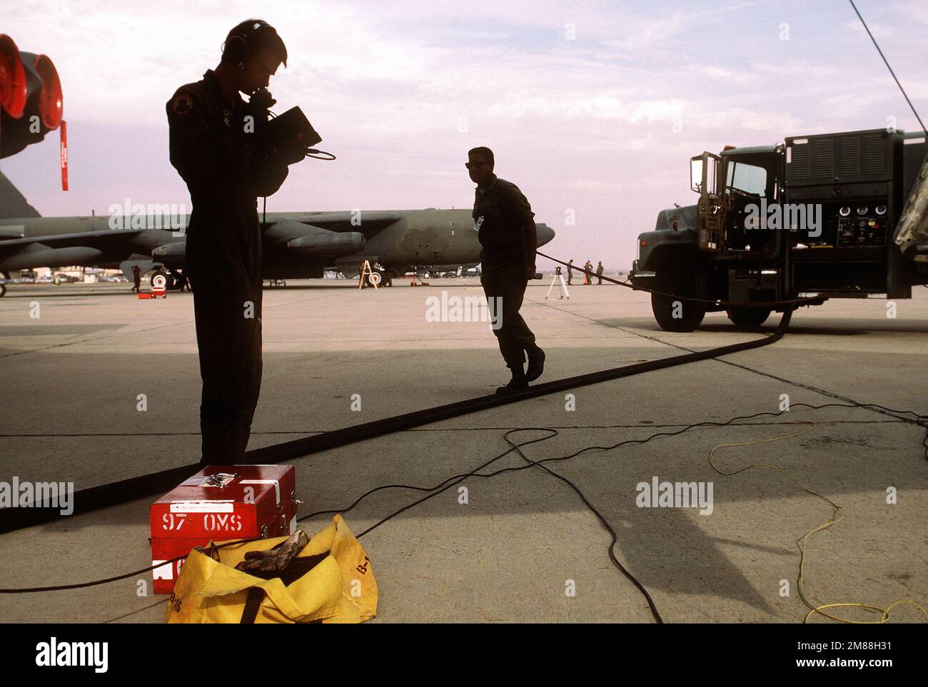 B-52 Stratofortress bomber crewman looks over checklist on flight line ...