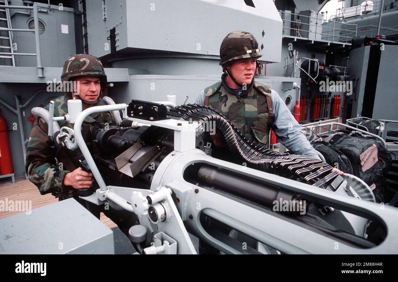 A member of the Marine Detachment mans a 25mm Mark 38, Mod 0 gun system ...