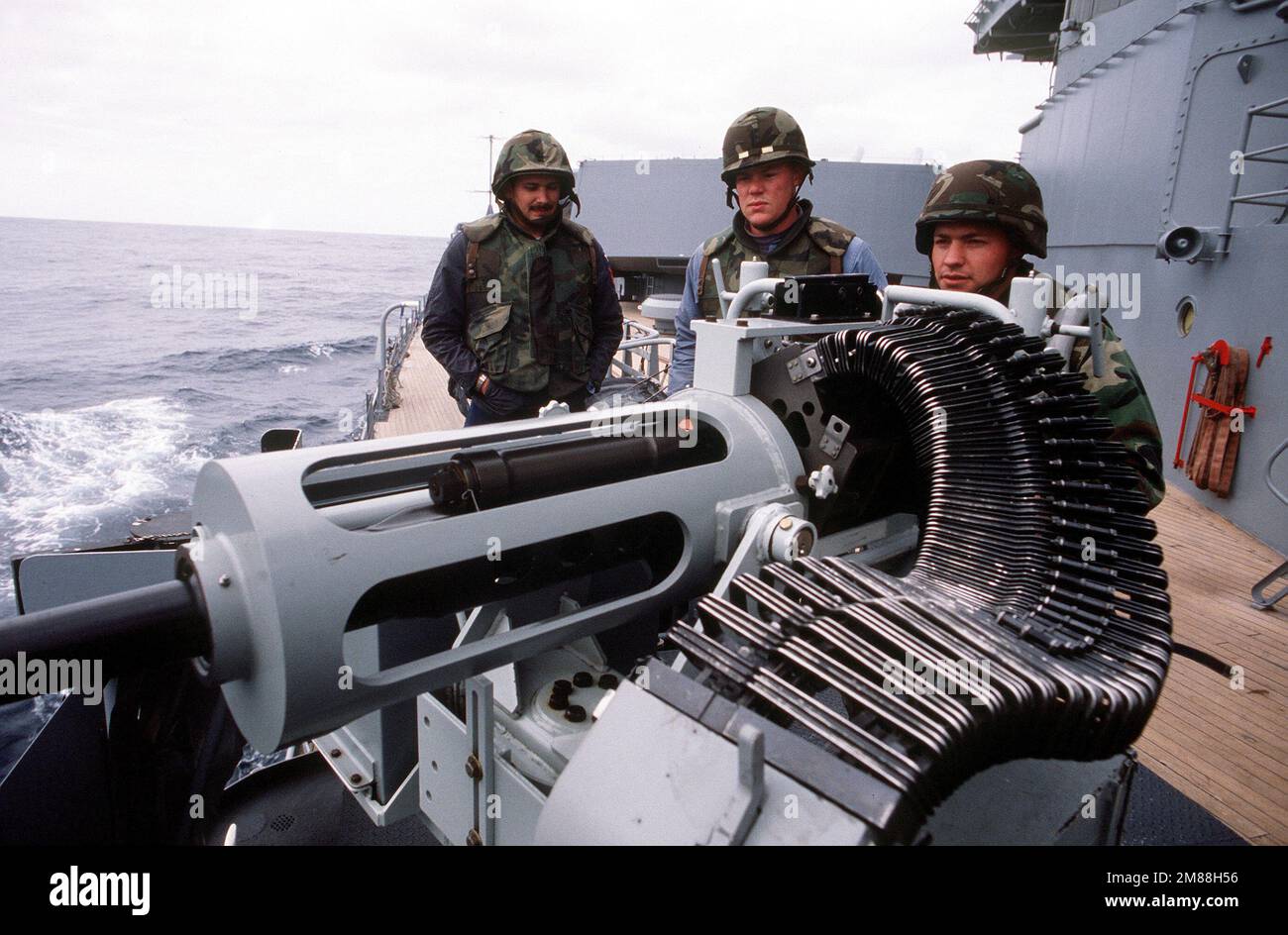 A member of the Marine Detachment mans a 25mm Mark 38, Mod 0 gun system ...